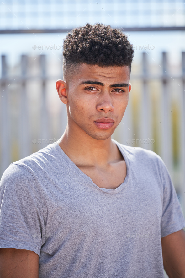 Portrait of serious black man looking at camera Stock Photo by ADDICTIVE_STOCK