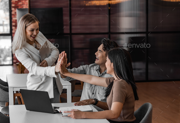 College students gather in the library for teamwork, project work, and ...