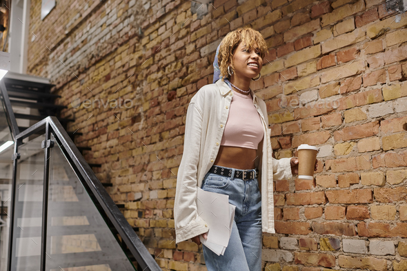 happy african american woman with braces holding papers, startup ...