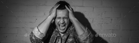Black and white photo of stressed military veteran screaming while ...