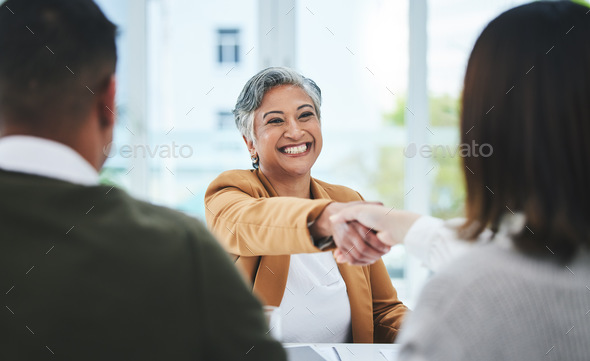 Handshake, job interview or business people with a happy mature woman ...