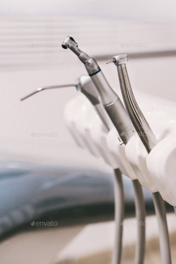 Vertical photo of electric polish dental instruments in a dental clinic ...