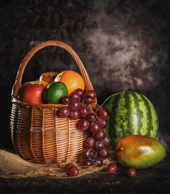 Vertical still life of fruits in a basket Stock Photo by wirestock