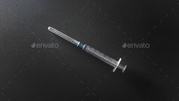 Empty syringe isolated on black background Stock Photo by wirestock