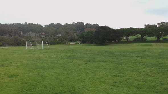 Afternoon drone view above a soccer field and moving forward near the ...