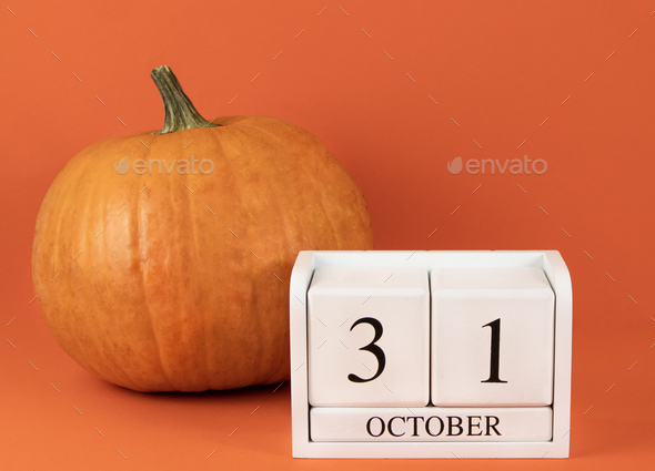 Halloween October 31 calendar and pumpkin on orange background. Stock ...