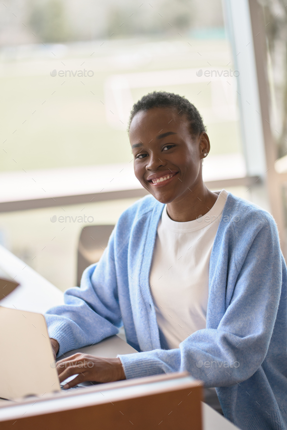 Happy African Black girl student using laptop computer. Vertical ...