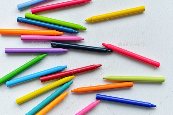 Bright colorful generic crayons on blank white paper - back to school ...