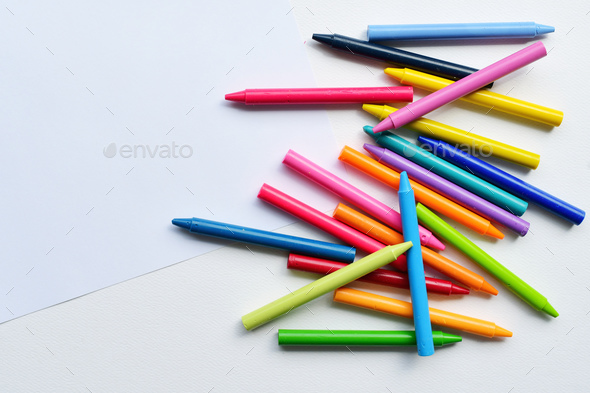 Bright colorful generic crayons on blank white paper - back to school ...