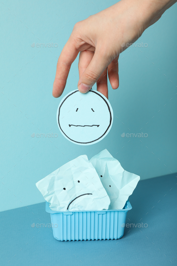 Blue box with papers with sad emoji and hand on blue background Stock ...