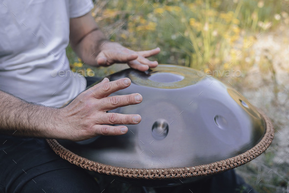 close-up side view of the hands of an unrecognizable man playing ...