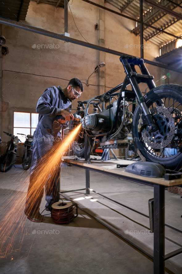 Adult male mechanic working in professional workshop Stock Photo by ...