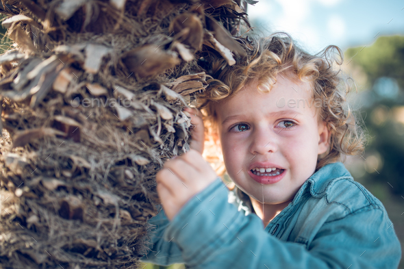 Crying boy near tree trunk Stock Photo by ADDICTIVE_STOCK | PhotoDune
