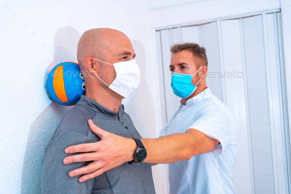 Healthcare professional guiding the patient at the rehabilitation gym ...