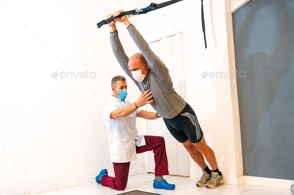 Healthcare professional guiding the patient at the rehabilitation gym ...