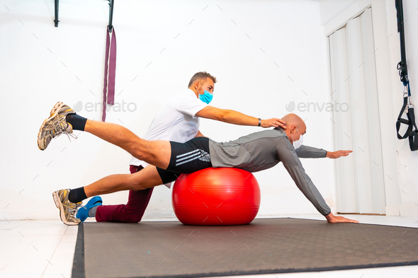Healthcare professional guiding the patient at the rehabilitation gym ...