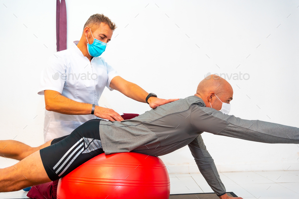 Healthcare professional guiding the patient at the rehabilitation gym ...