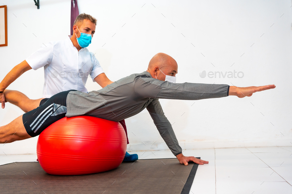 Healthcare professional guiding the patient at the rehabilitation gym ...