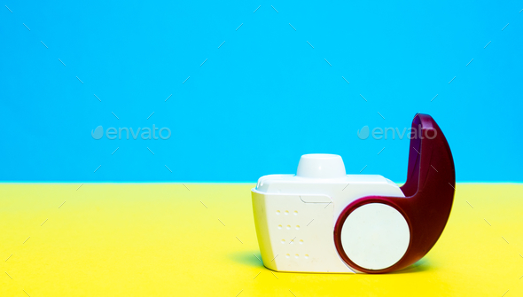 Asthma inhaler - a remedy for asthma and allergic diseases on a blue ...