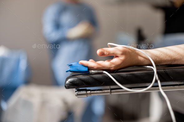 Patient's arm with a pulse oximeter in operating room Stock Photo by ...