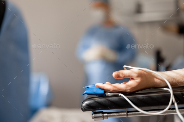 Patient's arm with a pulse oximeter in operating room Stock Photo by ...