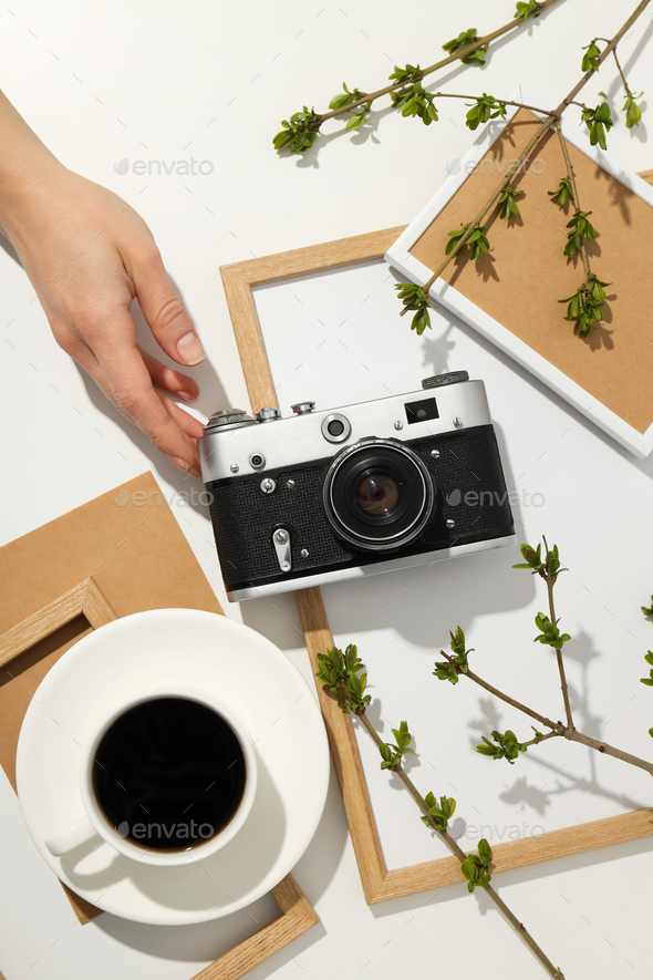 Vintage camera, photo frames and female hand on white background, top ...