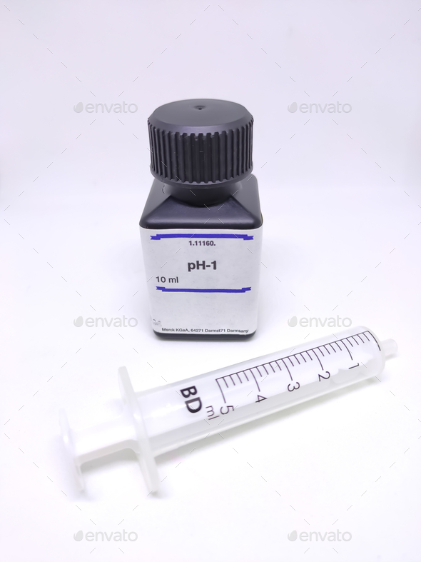 Closeup shot of water testing sample reagents with a syringe on the ...