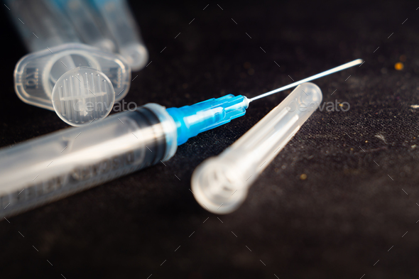 Close-up photo of an open syringe on a black surface Stock Photo by ...