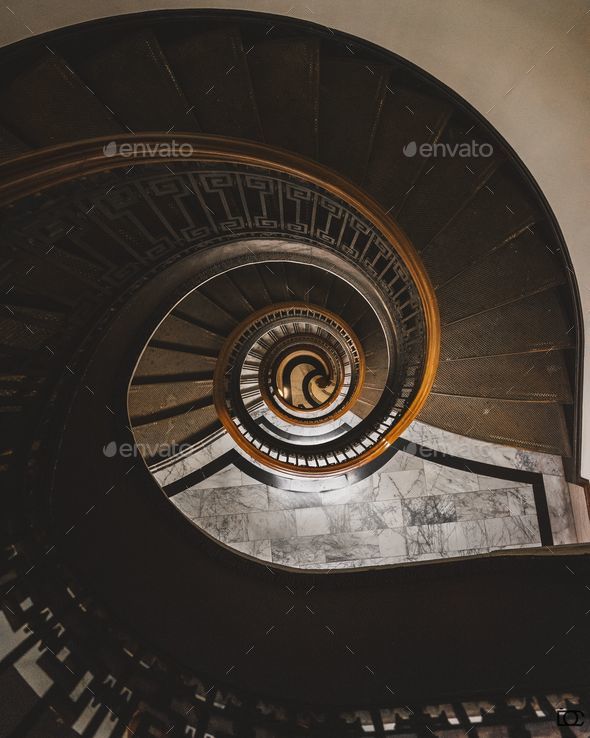 Vertical top view of spiral staircase with black and brown railings ...