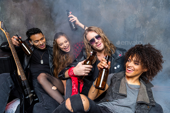 friends drinking beer after rehearse in studio, rock and roll band ...