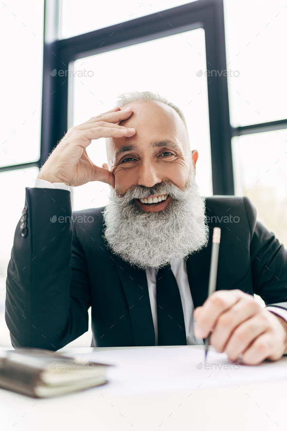happy smiling senior businessman at workplace signing documents Stock ...