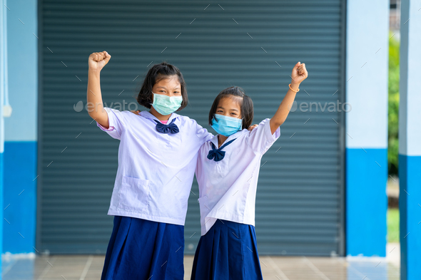 Elementary school students with face mask back at school after covid-19 ...