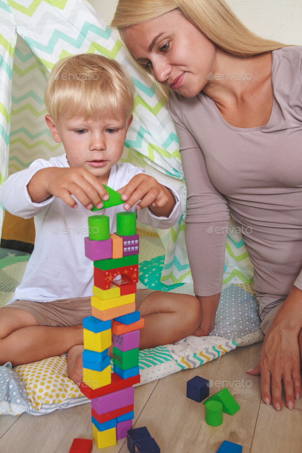 Mom and son build a tower together from constructor Stock Photo by ...