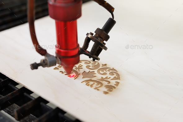 CNC Laser cutting wood. Laser cuts from plywood in production. Stock ...