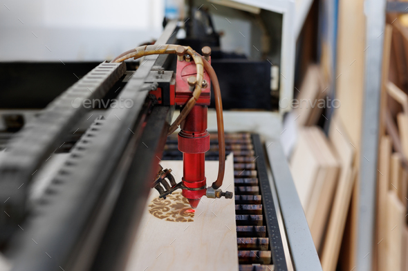 CNC Laser cutting wood. Laser cuts from plywood in production. Stock ...