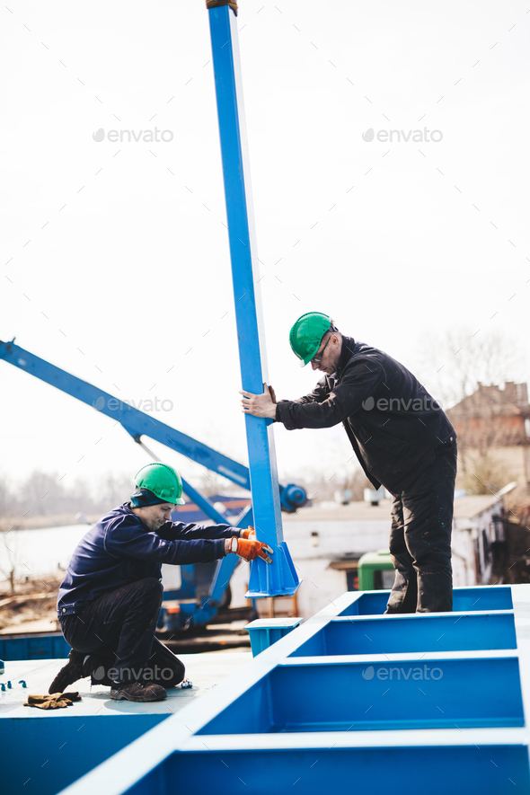 Manual worker working at shipyard construction site Stock Photo by ...