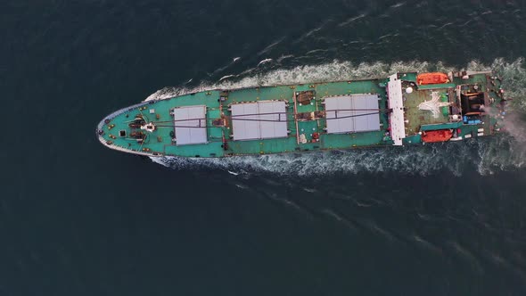 A Cargo Ship Sails on the Sea Making Waves at Sunset, Stock Footage