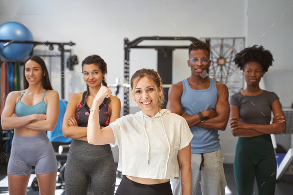 Multiethnic fitness group posing smiling in front of the camera at the ...