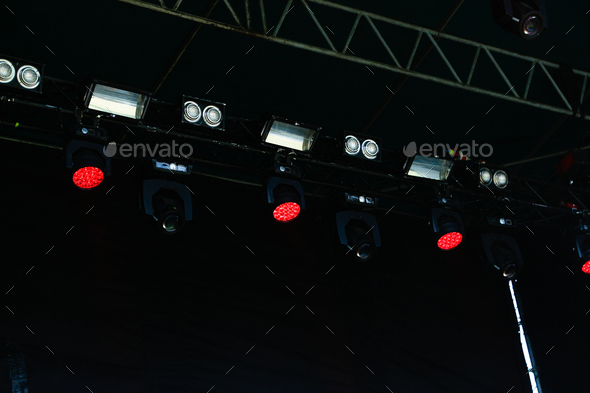 many red spotlights that illuminate the stage at a concert with fog ...