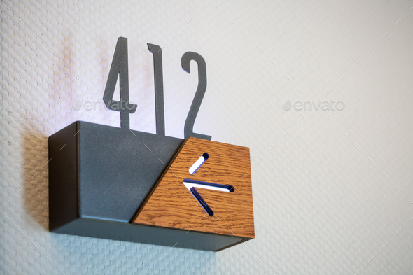 Closeup of 412 hotel room number with an arrow sign showing the ...