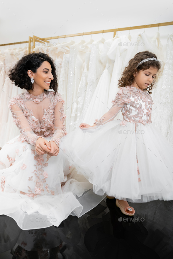 special moment, joyful middle eastern bride in floral wedding gown ...