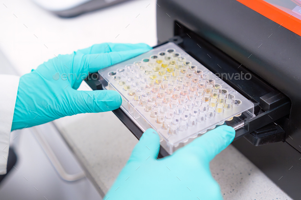 For analysis of multiple sample inserts a microplate into a microplate ...