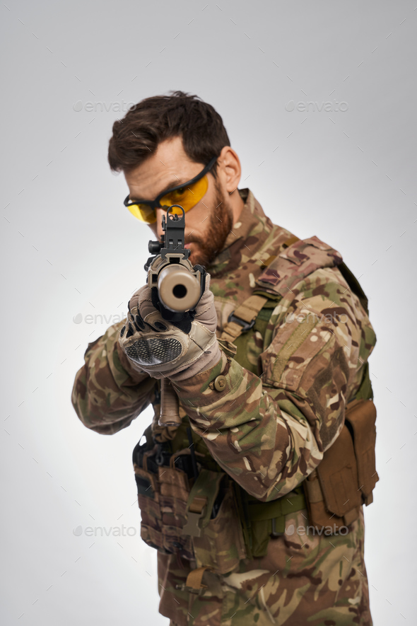 Focused infantryman aiming, by pointing machine gun to camera. Stock ...