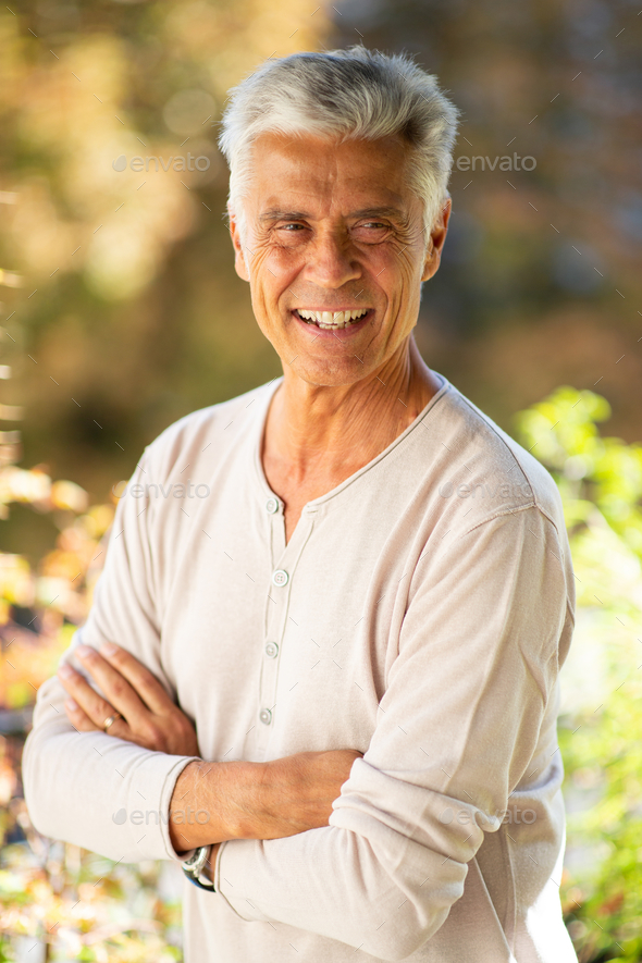 Close up handsome older man smiling with arms crossed Stock Photo by ...