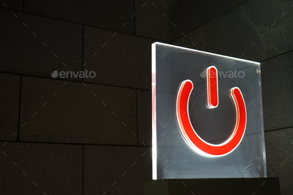 Red power symbol on a transparent surface on a wall background Stock ...
