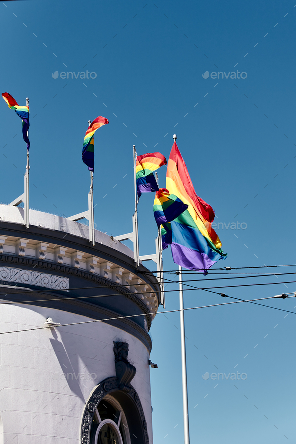 Vertical shot of the pride flags on top of a building in San Francisco ...