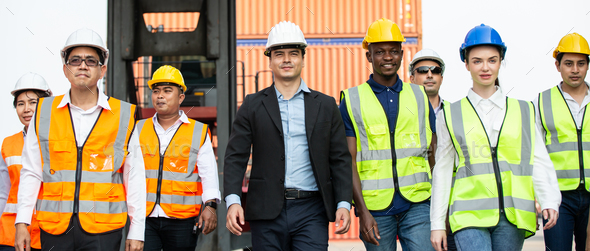Corporate logistic team walking together at container warehouse Stock ...