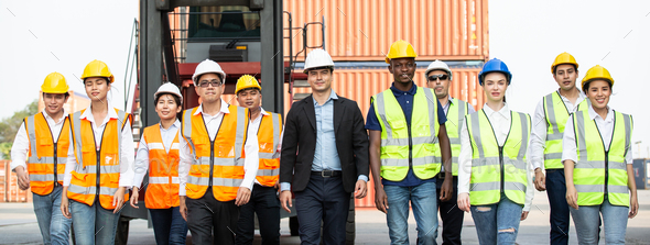 Corporate logistic team walking together at container warehouse Stock ...
