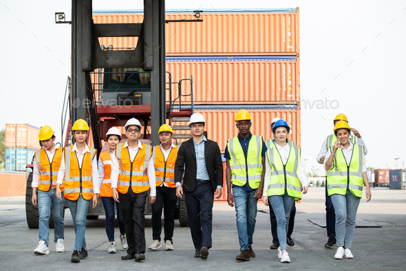 Corporate logistic team walking together at container warehouse Stock ...