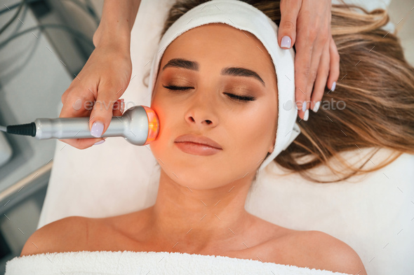 Apparatus for galvanization is used. Woman face getting facial care by ...